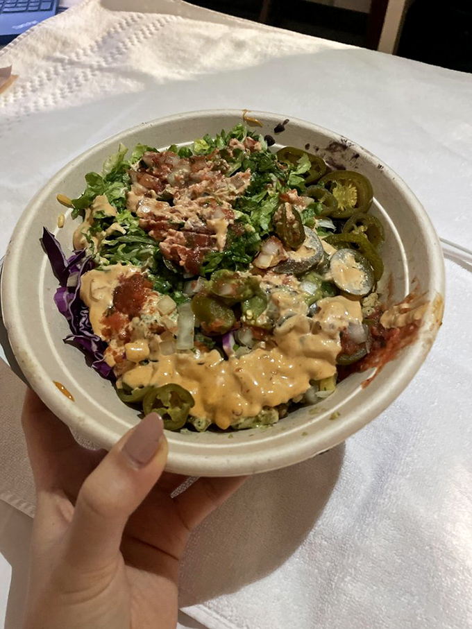 A bowl that proves salads can be exciting—crisp greens, vibrant toppings, and sauces that make you forget you're technically eating something healthy.