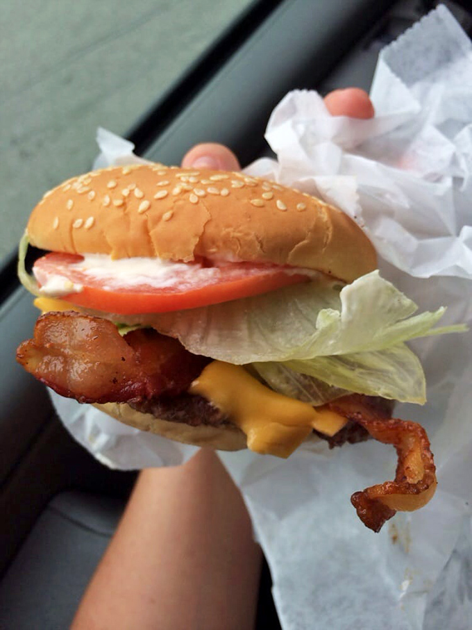 This isn't just a burger&mdash;it's edible architecture. Layers of melty cheese, crisp bacon, and fresh veggies create a masterpiece that requires both hands and several napkins.