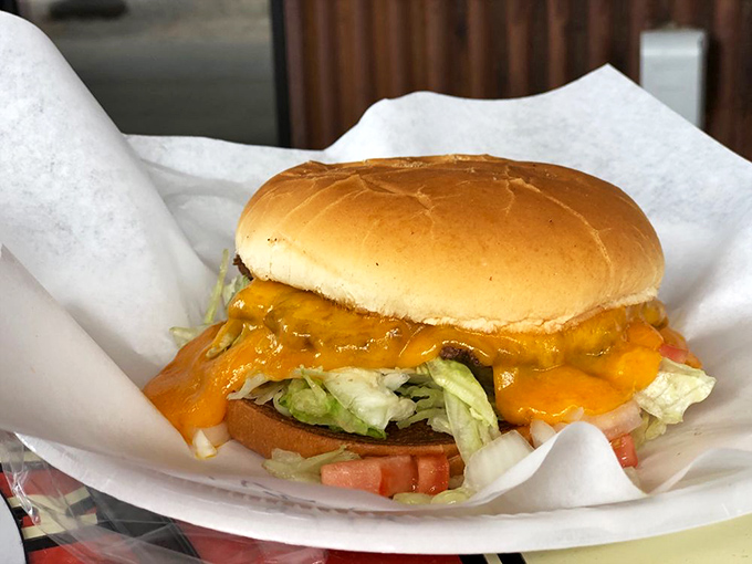 Behold the Cheddar Cheezy in all its glory—where cheese doesn't just top the burger, it creates a magnificent golden halo that crackles with each bite.