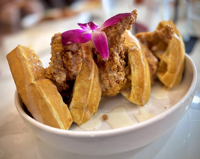 Golden waffles cradle perfectly seasoned chicken in a sweet-and-savory symphony that'll haunt your dreams in the best way.