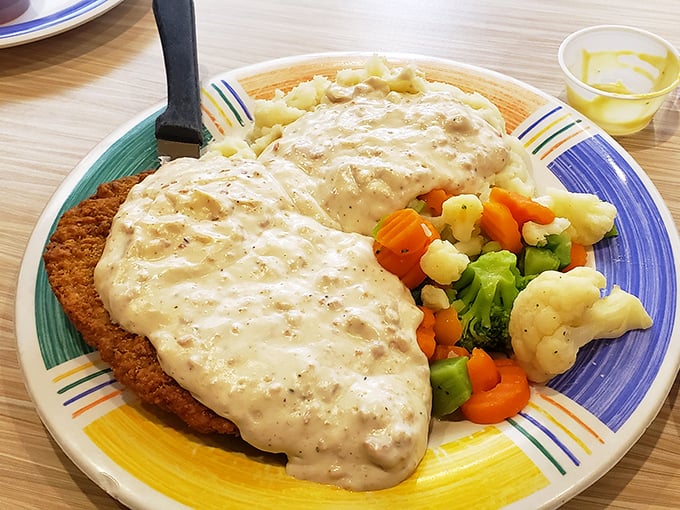This isn't just dinner&mdash;it's edible therapy. Crispy chicken fried steak smothered in pepper gravy with a vegetable medley that counts as "eating healthy."