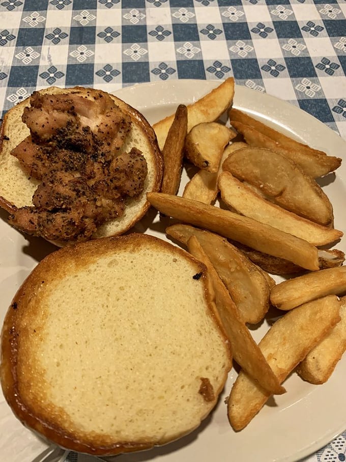 A sandwich that demands two hands and zero distractions &ndash; crispy chicken nestled in a bun with fries standing guard.