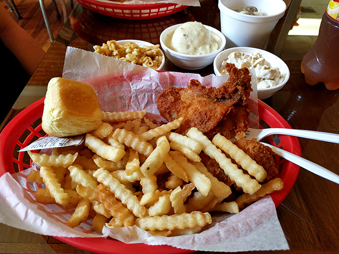 The classic basket presentation - crinkle-cut fries, perfectly fried chicken, and sides of creamy goodness - comfort food mathematics at its finest.