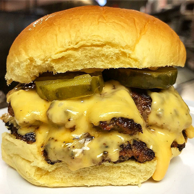 The double stack&mdash;where cheese cascades like a yellow waterfall over beautifully caramelized patties. Those pickles aren't garnish; they're essential supporting actors in this meaty drama.