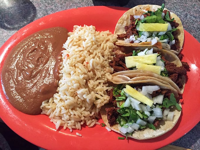 The holy trinity of tacos, rice, and beans. Simple math: three perfect tacos plus lime wedges equals the kind of meal mathematicians and food lovers can agree on.