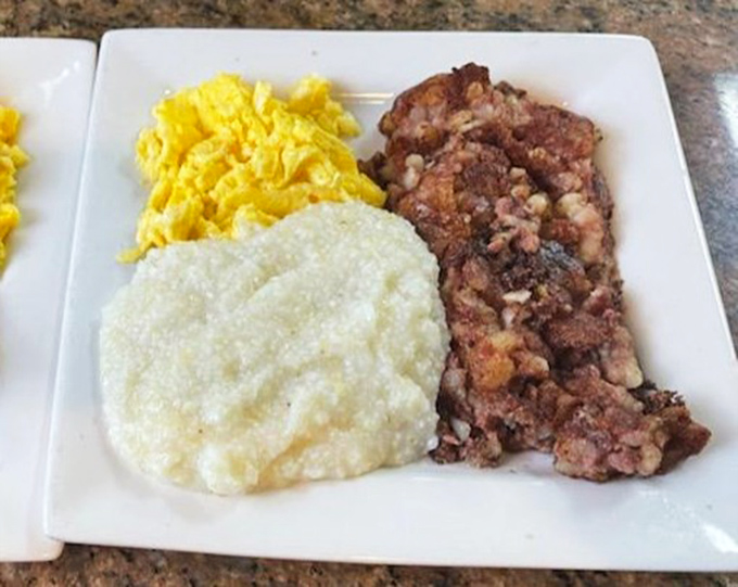 Breakfast perfection: creamy grits, fluffy scrambled eggs, and corned beef hash with the kind of crispy edges worth setting an alarm for.