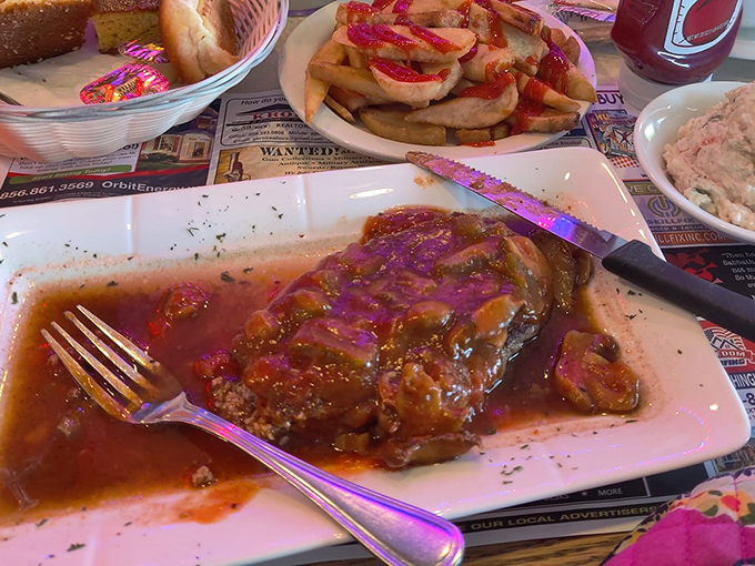 Behold the gravitational pull of a proper diner entree &ndash; juicy salisbury steak bathed in rich brown gravy, with crispy fries standing by for the inevitable dipping.