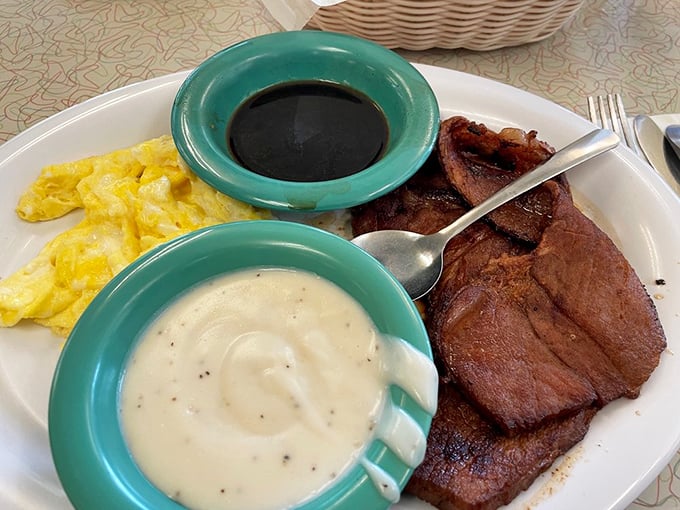 Country ham and gravy&mdash;the breakfast equivalent of a warm Southern hug. Those turquoise gravy boats aren't just serving food; they're delivering happiness.