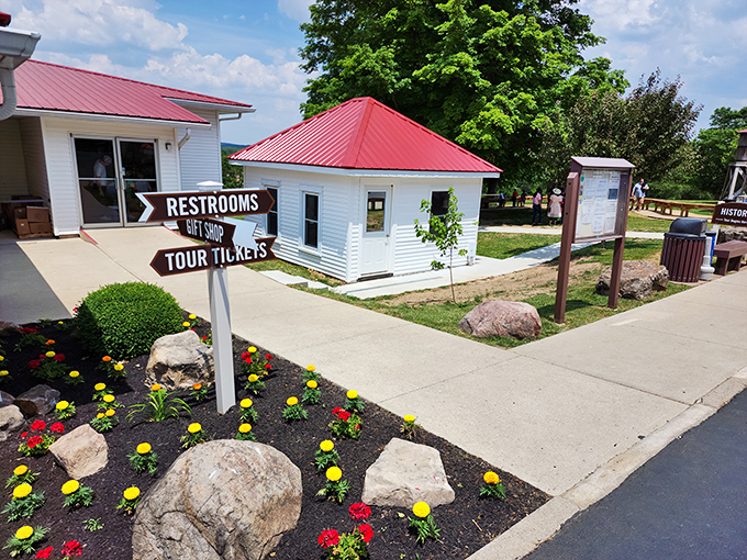 Even underground adventures need proper signage. This charming directional post ensures you'll find restrooms before exploring nature's subterranean art gallery.