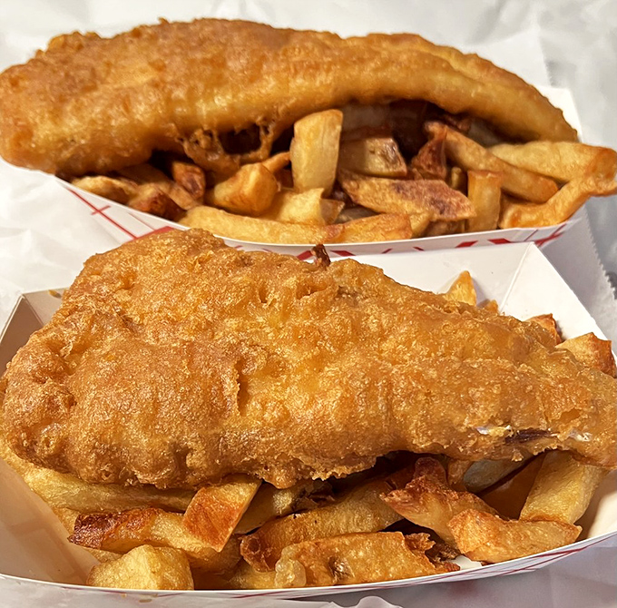 Two golden treasures nestled in paper boats&mdash;the kind of fish and chips that make you question why you've wasted time on lesser versions.