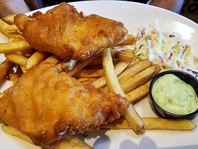 Golden-battered fish that crunches like your favorite childhood memory, paired with fries that achieve the perfect balance between crisp exterior and fluffy interior.
