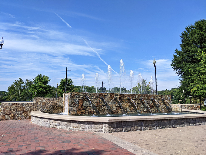 The downtown fountain creates an urban oasis where the soothing sounds of cascading water provide nature's soundtrack to city life.