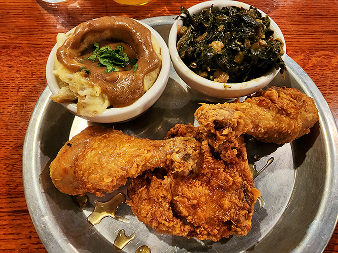 This isn't just comfort food &ndash; it's therapy on a metal tray. The golden chicken, creamy mac and cheese, and collards form a holy trinity of Southern bliss.