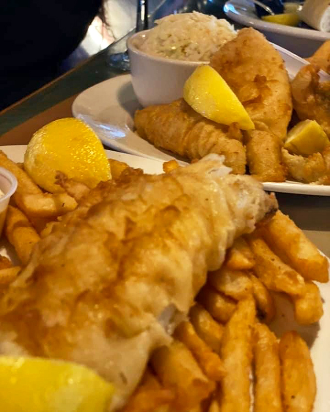 Golden-battered fish meets crispy fries in a marriage so perfect it makes you wonder why the ocean and potato ever lived apart.