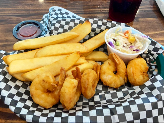 Golden-battered shrimp that crunch like nature's potato chips, served with fries so perfect they deserve their own fan club.