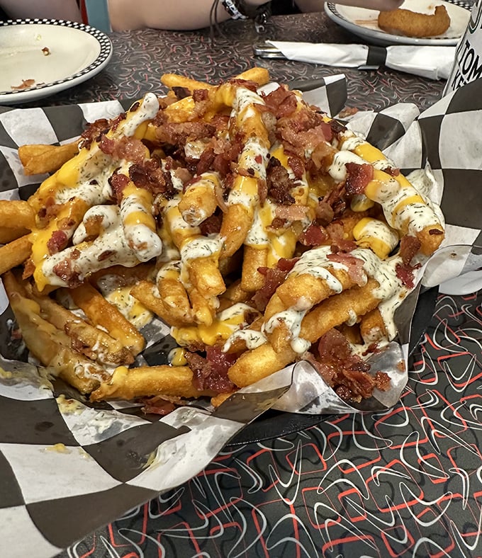 These aren't just loaded fries—they're a support group of potatoes that decided more is more, especially when "more" means cheese, bacon, and ranch dressing.