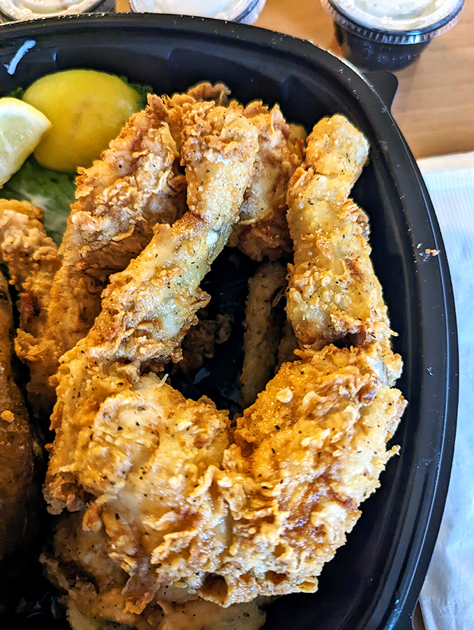 Golden-battered fried shrimp that crunch louder than your diet plans breaking. The lemon wedge is just there for plausible deniability.