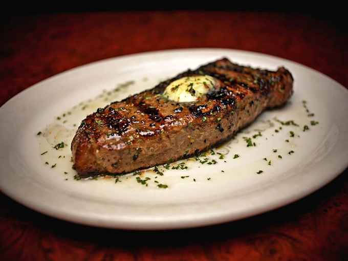 This steak, sporting those coveted crosshatch grill marks and topped with herb butter, isn't just dinner &ndash; it's edible performance art you created yourself.