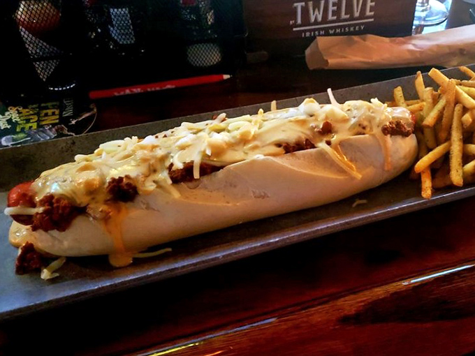 Not your ballpark hot dog. This loaded masterpiece transforms the humble frankfurter into a cheese-smothered main event worthy of its own spotlight.