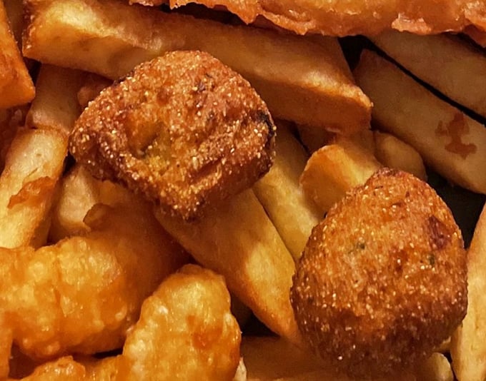 These aren't your average hush puppies; they're crispy little spheres of Southern-meets-British comfort food magic.