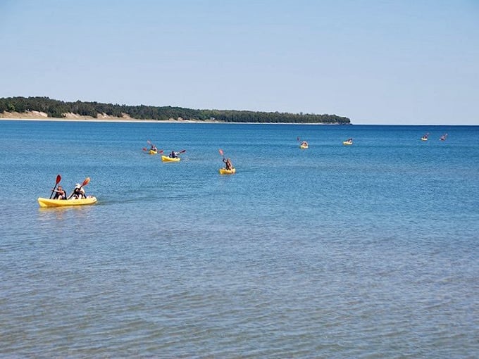 Kayakers dot the turquoise waters like colorful confetti. Lake Michigan shows off its Caribbean-blue hues, proving Wisconsin can deliver postcard-perfect beach days.