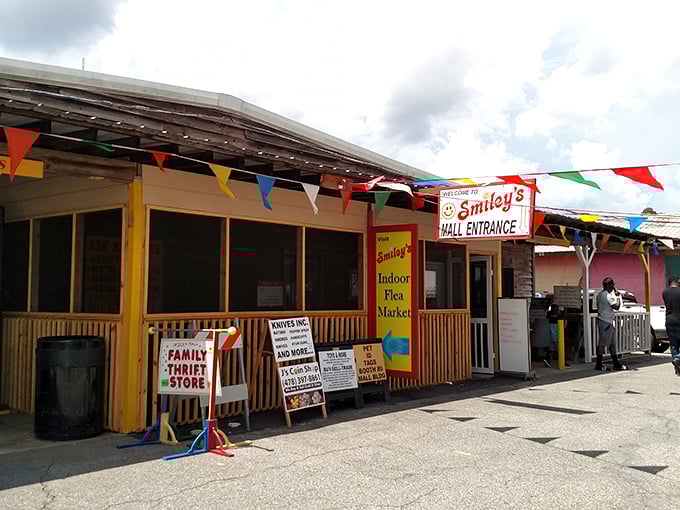 The gateway to bargain bliss! Smiley's Mall Entrance welcomes weekend warriors with colorful pennants and the promise of treasures within.