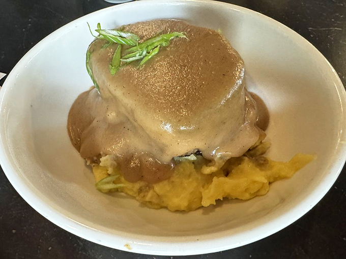 Comfort food that hugs your soul. This meatloaf nestled on creamy mashed potatoes and smothered in gravy is what rainy day dreams are made of.