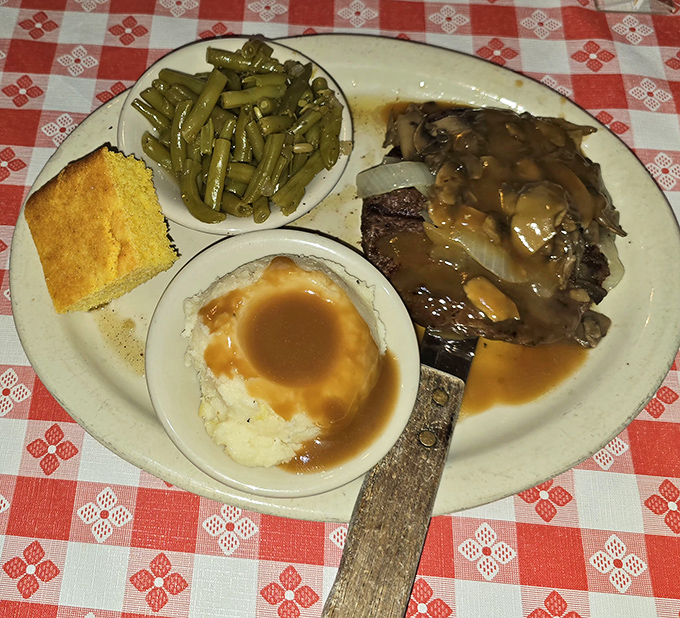 This isn't just dinner, it's edible nostalgia. Meatloaf, green beans, and mashed potatoes with gravy pooling in the center like a savory wishing well.