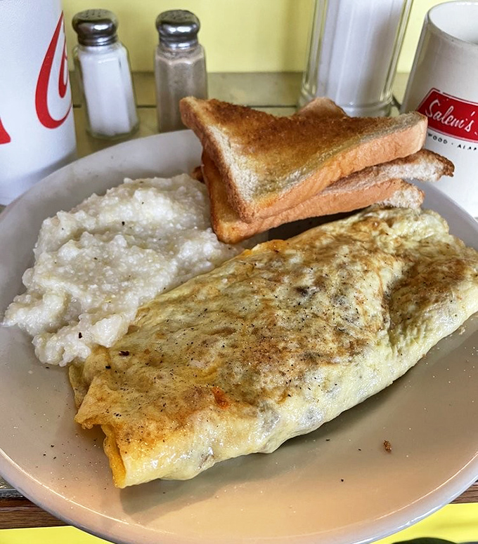 This omelet doesn't need Instagram filters—it's naturally photogenic with its perfectly folded exterior and fluffy interior. Paired with grits that would make any Southerner proud.