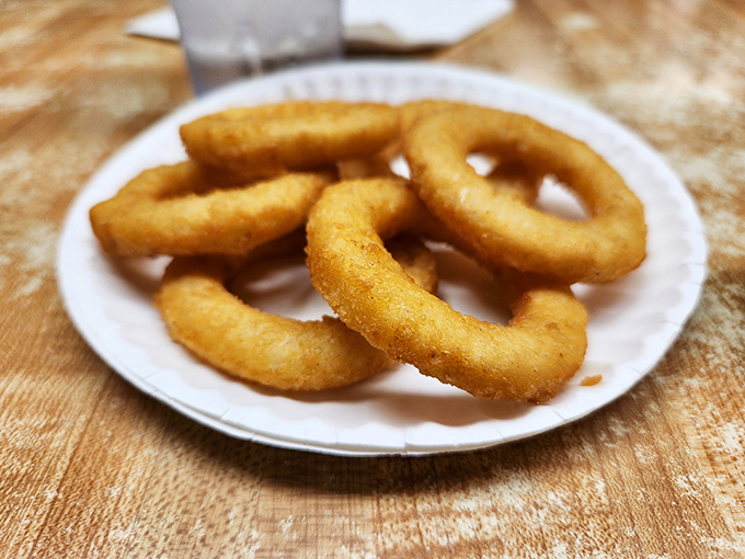 Golden onion rings that crunch like autumn leaves—except these rings won't have you doing yard work afterward.