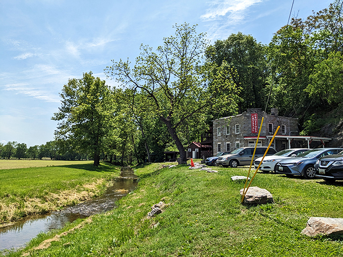 A peaceful stream meanders past the cavern entrance, completely unaware of the spectacular underworld just feet away.