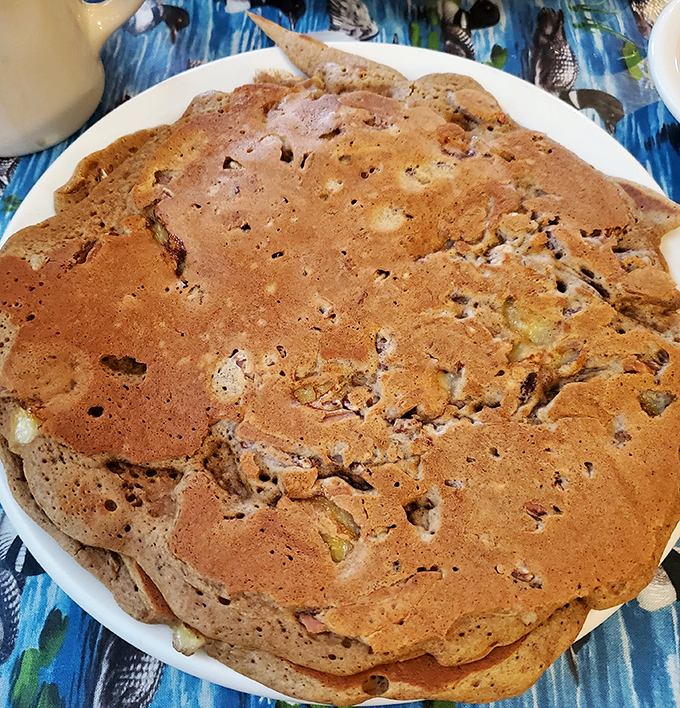 This glorious disc of gingerbread-banana-pecan perfection isn't just a pancake; it's what clouds dream of becoming when they grow up.