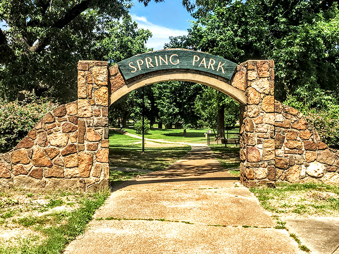 Spring Park's stone archway isn't just an entrance &ndash; it's a portal to simpler pleasures like picnics, people-watching, and actual face-to-face conversations.