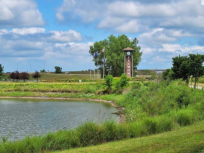Fremont's welcome sign greets visitors beside tranquil waters, promising a place where retirement dollars create ripples of possibility rather than waves of financial anxiety.