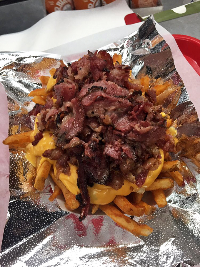 Pastrami fries topped with enough bacon to make your cardiologist schedule an intervention meeting immediately.