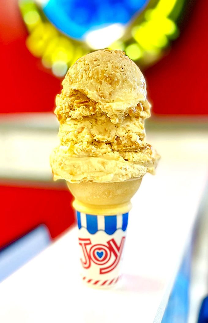 Ice cream stacked higher than your childhood dreams. This peanut butter masterpiece isn't just dessert&mdash;it's therapy in a "Joy" cone.