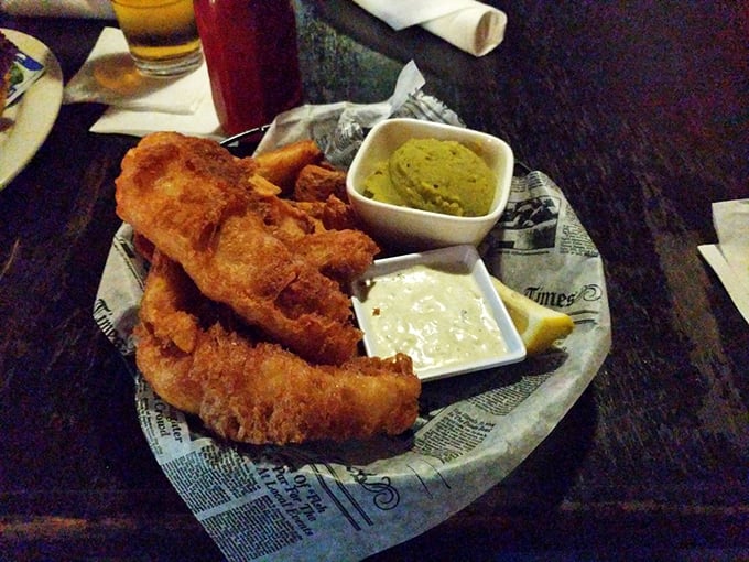Newspaper-lined plates aren't just for show&mdash;they're tradition. Crispy fish, proper chips, and those distinctive mushy peas create the holy trinity of British pub fare.