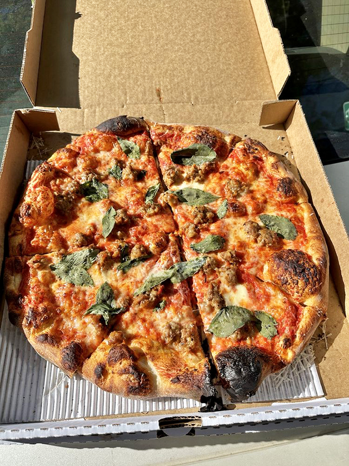 Pizza perfection in its most honest form. The blistered crust, vibrant sauce, and fresh basil create a harmony that would make even Italian nonnas nod in approval.