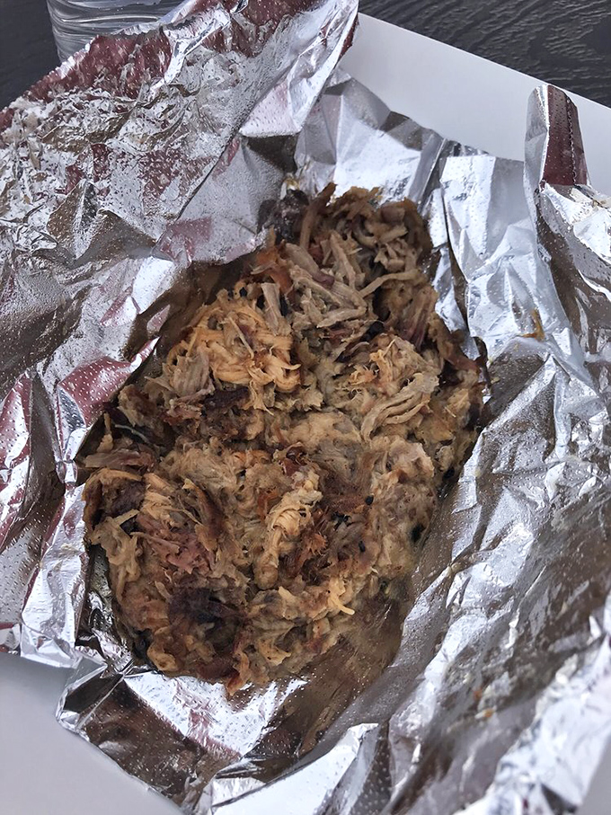 Pulled pork that looks like it's auditioning for a food magazine. Each tender strand carries the perfect balance of smoke and seasoning.