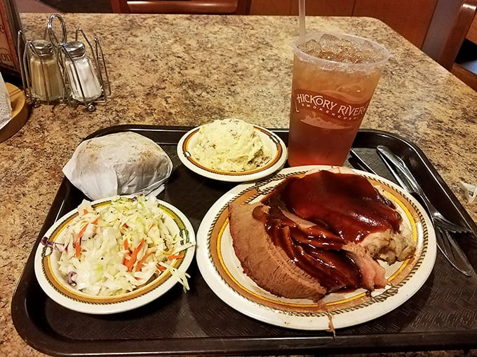 A complete barbecue experience: pulled pork, creamy slaw, and mashed potatoes, with sweet tea standing by for the inevitable meat sweats.