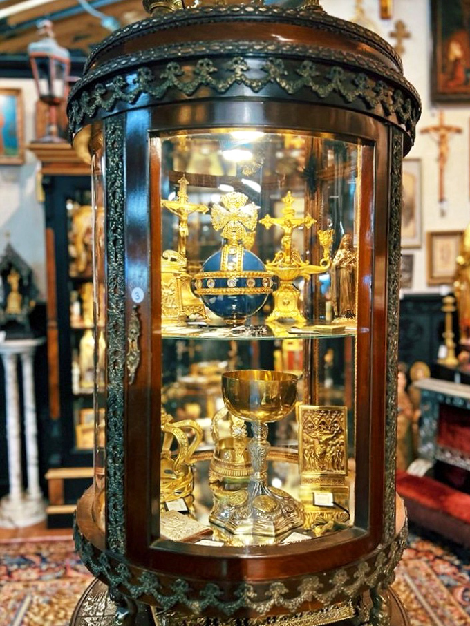Ornate religious artifacts gleam behind glass, reminding us when craftsmanship was truly a devotional act.