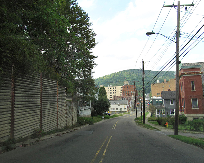 Residential streets wind through Bradford's neighborhoods, where hills cradle modest homes and utility poles string together a community.