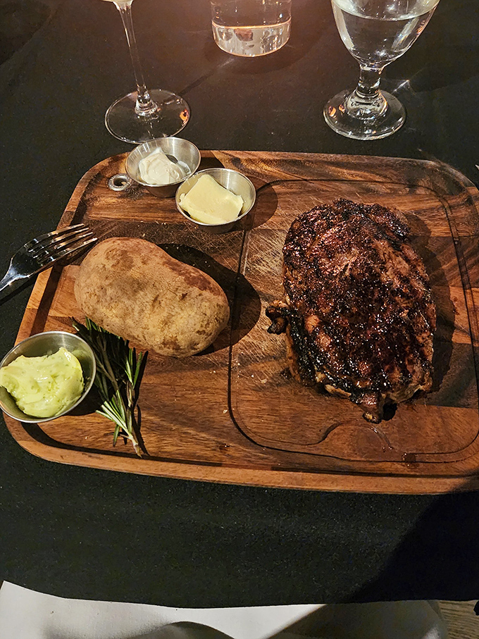 This isn't just a steak—it's a wooden board carrying edible happiness. The ribeye's caramelized crust whispers sweet nothings to your taste buds before you even take a bite.