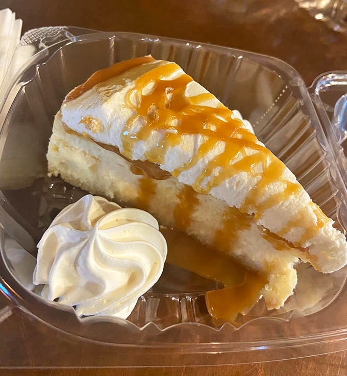 Salted caramel cheesecake with a dollop of whipped cream&mdash;where sweet meets salty in a dance that makes your fork do the tango.