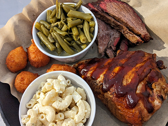 A barbecue platter that belongs in the Louvre&mdash;mac and cheese that's actually worthy of the meat, green beans that haven't surrendered all dignity, and chicken wearing sauce like a designer outfit.