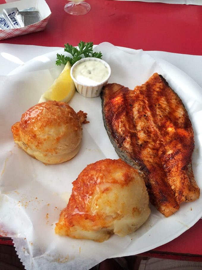 Romano potatoes and perfectly grilled fish &ndash; proof that simplicity, when executed flawlessly, outshines complexity every time. The plate may be paper, but the flavors are five-star.