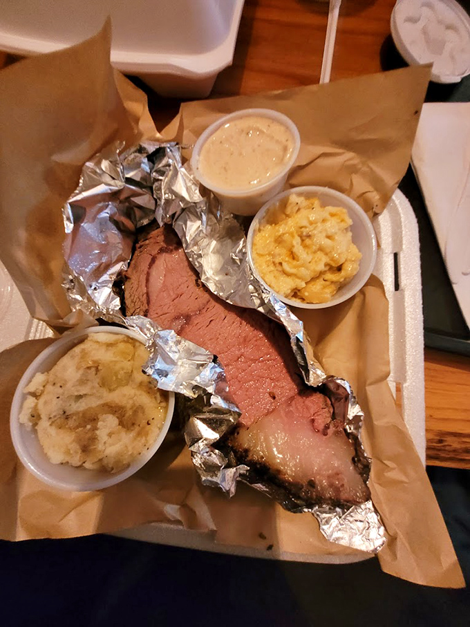 Behold the brisket in all its pink-ringed glory, flanked by sides that refuse to be mere supporting characters in this meaty drama.