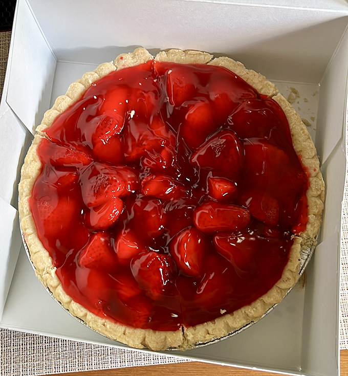 Fresh strawberry pie that looks like it's auditioning for a magazine cover. Those berries aren't just red—they're showboating.