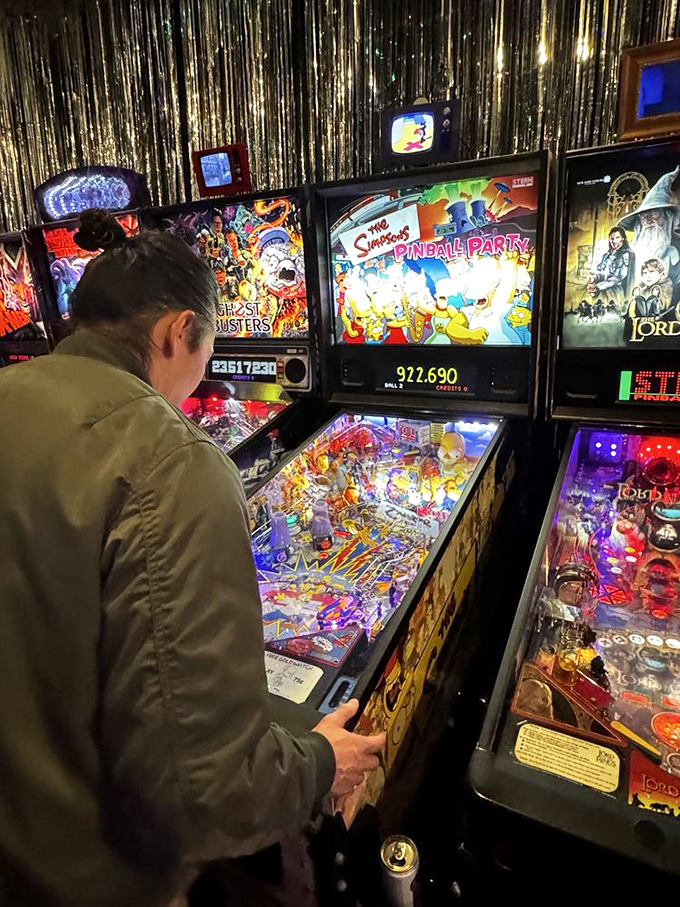 Deep in concentration, this player navigates The Simpsons Pinball Party. Homer would approve of this level of focus.
