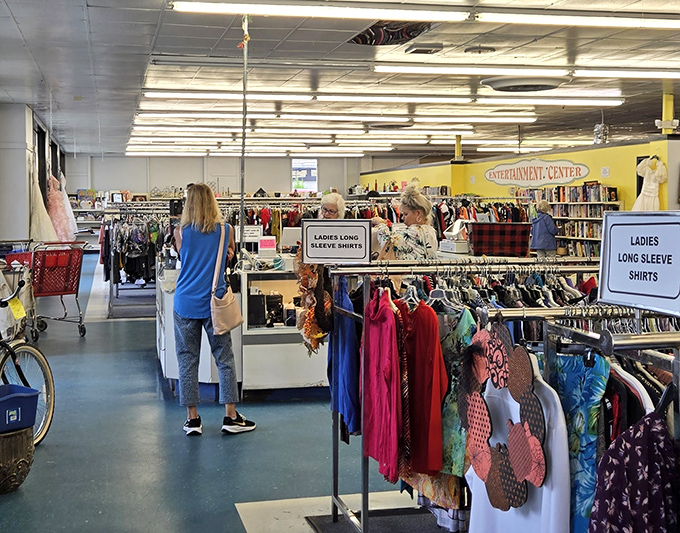 The women's clothing section: meticulously organized chaos where "Ladies Long Sleeve Shirts" isn't just a sign&mdash;it's a treasure map to your next favorite blouse.